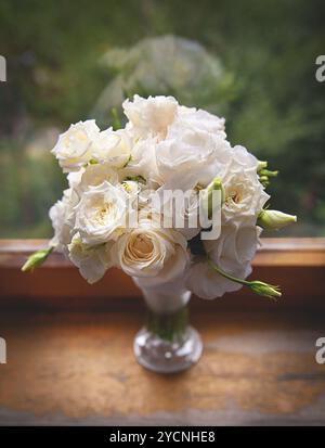 Vase with beautiful roses near window Stock Photo - Alamy