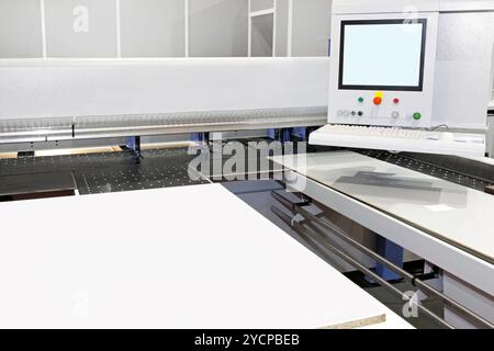 Modern wood panel saw with monitor in workshop Stock Photo - Alamy