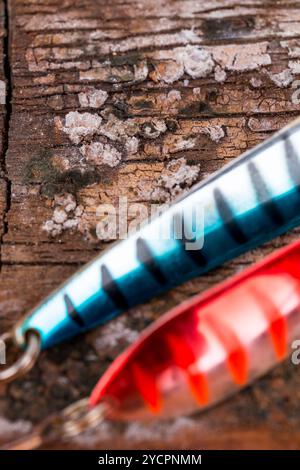 Closeup of colorful different fishing lures and hooks on a black ...