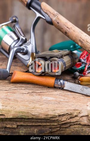 Fishing and tourism gear on timber board Stock Photo - Alamy