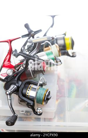 Different fishing reels with line on wooden background Stock Photo - Alamy