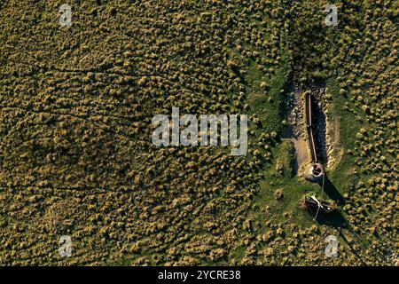 Aerial view of countryside shadoof well in meadow pasture by drone ...