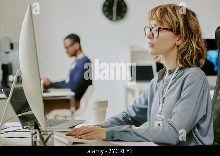Young woman working on desktop computer Stock Photo - Alamy