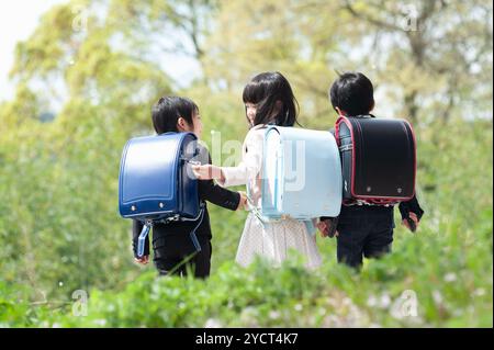 Three new first-year students standing side by side in formal dress ...