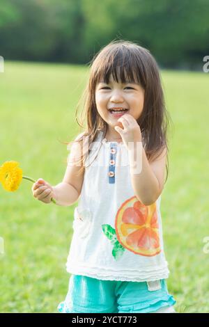 Girl smiling happily after receiving flowers Stock Photo - Alamy