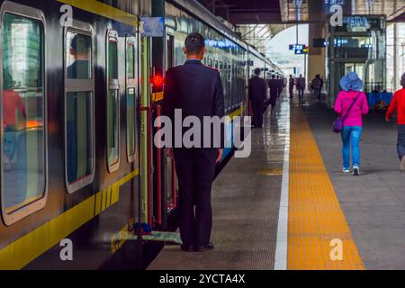 Conductor at train station, Xining, China Stock Photo - Alamy