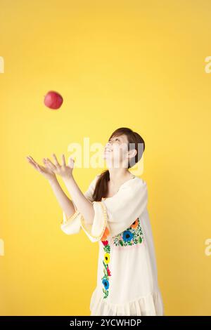 Woman catching an apple Stock Photo - Alamy