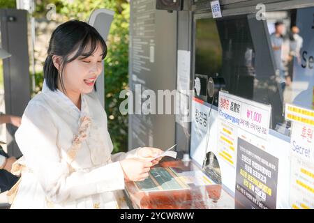 A Korean couple in their 20s buys tickets at a historical building in ...