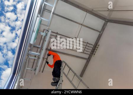 stainless steel piping installed in the ceiling by an african american ...
