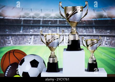 Cups of winners award, Sport equipment and balls Stock Photo - Alamy