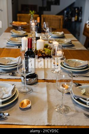 Elegant dining setup with wine and candlelight Stock Photo - Alamy