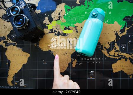 Map of the world in Russian. The finger of the girl points to different ...