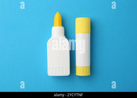 Different types of glue on light blue background, flat lay Stock Photo ...