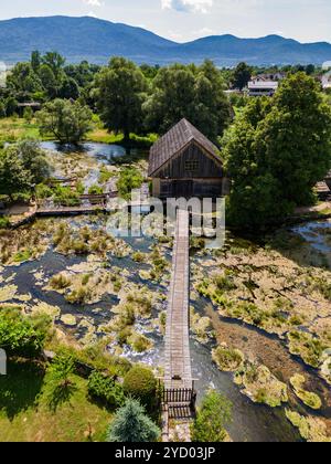 Drone view of wooden mill houses of Majerovo Vrilo located on Gacka ...