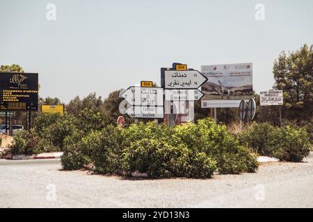 In a busy Moroccan suburb, various road signs direct traffic while ...