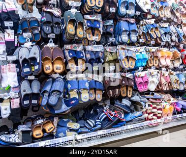 Different slippers selling at the showcase Stock Photo - Alamy