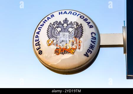 Emblem of the Federal Tax Service of Russia and russian banknotes close ...