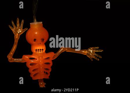 Plastic skeleton hand on a black background Stock Photo - Alamy