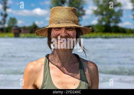 Farmhands tend crops at ecological farm Stock Photo - Alamy