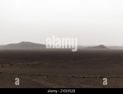Sandstorm in a dry desert under a cloudy sky with dark clouds Stock ...
