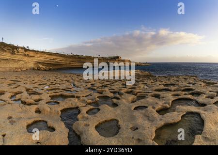 A view of the tidal pools and cliffs at Il-Hofra z-Zghira Bay in Malta ...