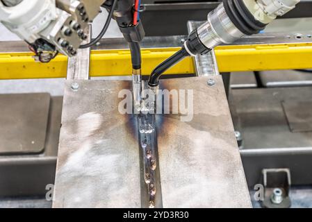 Robot welds steel. Welding head. Welding robot. CNC welding ...