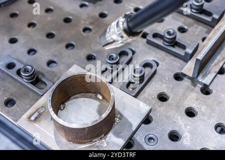 Robot welds steel. Welding head. Welding robot. CNC welding ...