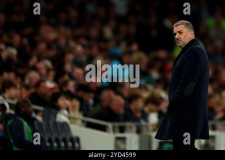 Tottenham Hotspur manager Ange Postecoglou with the trophy on stage ...