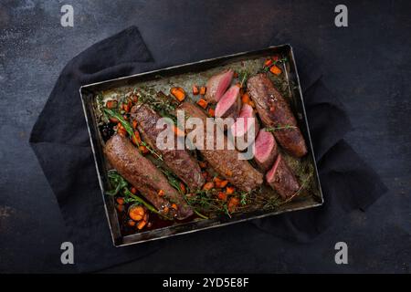 Traditional fried venison back filet with kaki fruit Stock Photo - Alamy