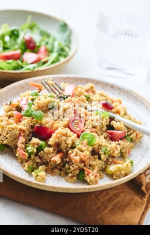 Couscous with roasted tomatoes and vegetables in a bowl. Fresh ...
