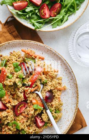 Couscous with roasted tomatoes and vegetables in a bowl. Fresh ...