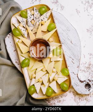 Cheese mix with honey and grapes on a stone background Stock Photo - Alamy