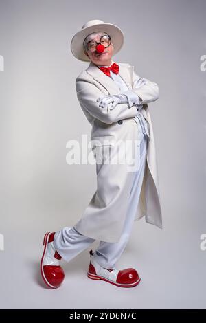 Ð¡lown in a white coat and hat with walking stick with a cocky ...