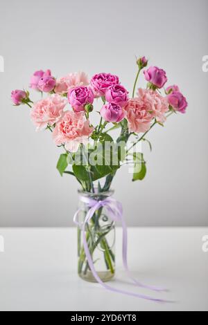 Bouquet of lilac roses and pink carnations Stock Photo - Alamy