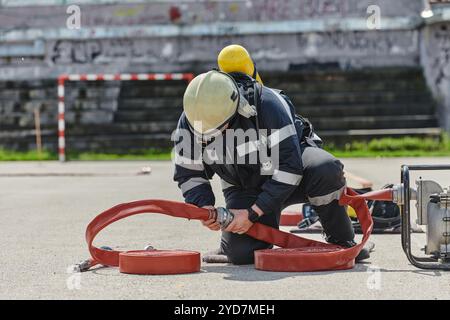 A firefighter dons the essential components of their professional gear ...
