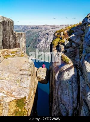 A lone hiker on a trail with stunning canyon views and rugged rocky ...