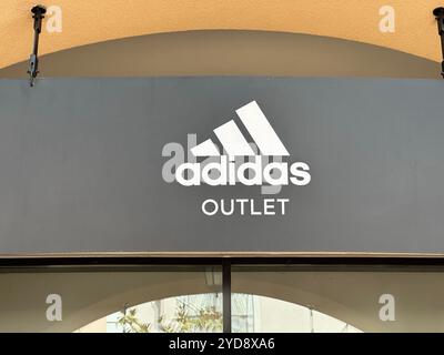 Adidas outlet store storefront logo and banner Stock Photo - Alamy