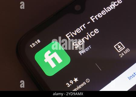 In this photo illustration, the Fiverr logo is displayed on a ...