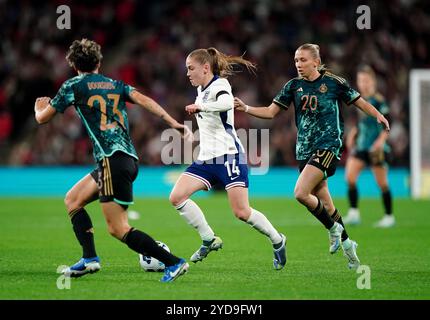 Germany's Elisa Senb (centre) battles for the ball with England's ...