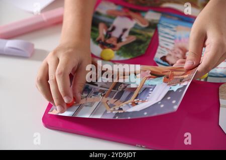 Creating vision board with different pictures at light table, closeup ...