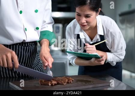 Student cooking apprentice Take notes on every step as the chef cooks ...