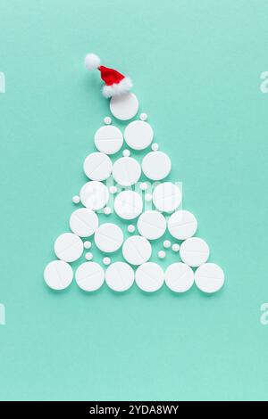 Creative arrangement of white pills forming Christmas tree with red ...
