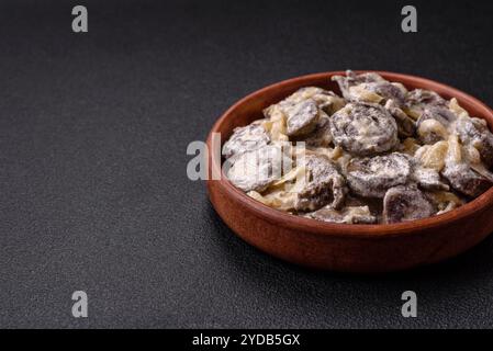 Boiled chicken hearts cut into slices with onions and cream sauce Stock ...