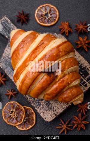 Delicious crispy sweet croissant cornet with chocolate on a dark ...