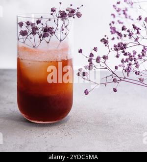 Cold brew coffee with ice cubes and milk, light background. Vertical ...