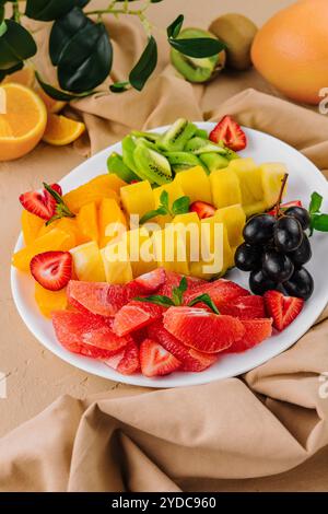 Sliced fruit mix on a plate, orange, watermelon, grape Stock Photo - Alamy