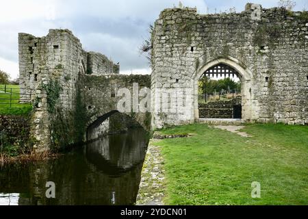 Ruins of The Medieval Barbican and Mill at Leeds castle under a grey ...