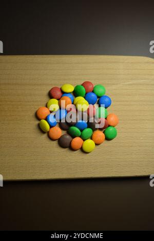 Beautiful bright small colored round candies with chocolate filling are ...