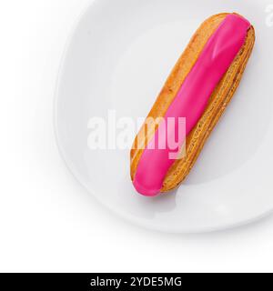 Eclair dessert with pink icing on white table Stock Photo - Alamy