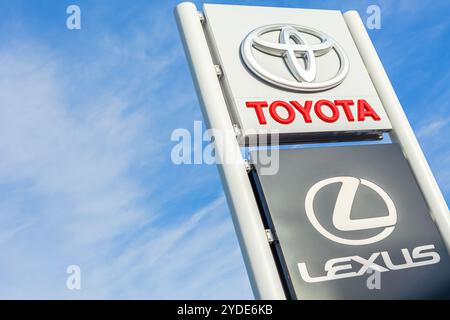 Toyota brand logo on bright blue sky background Stock Photo - Alamy